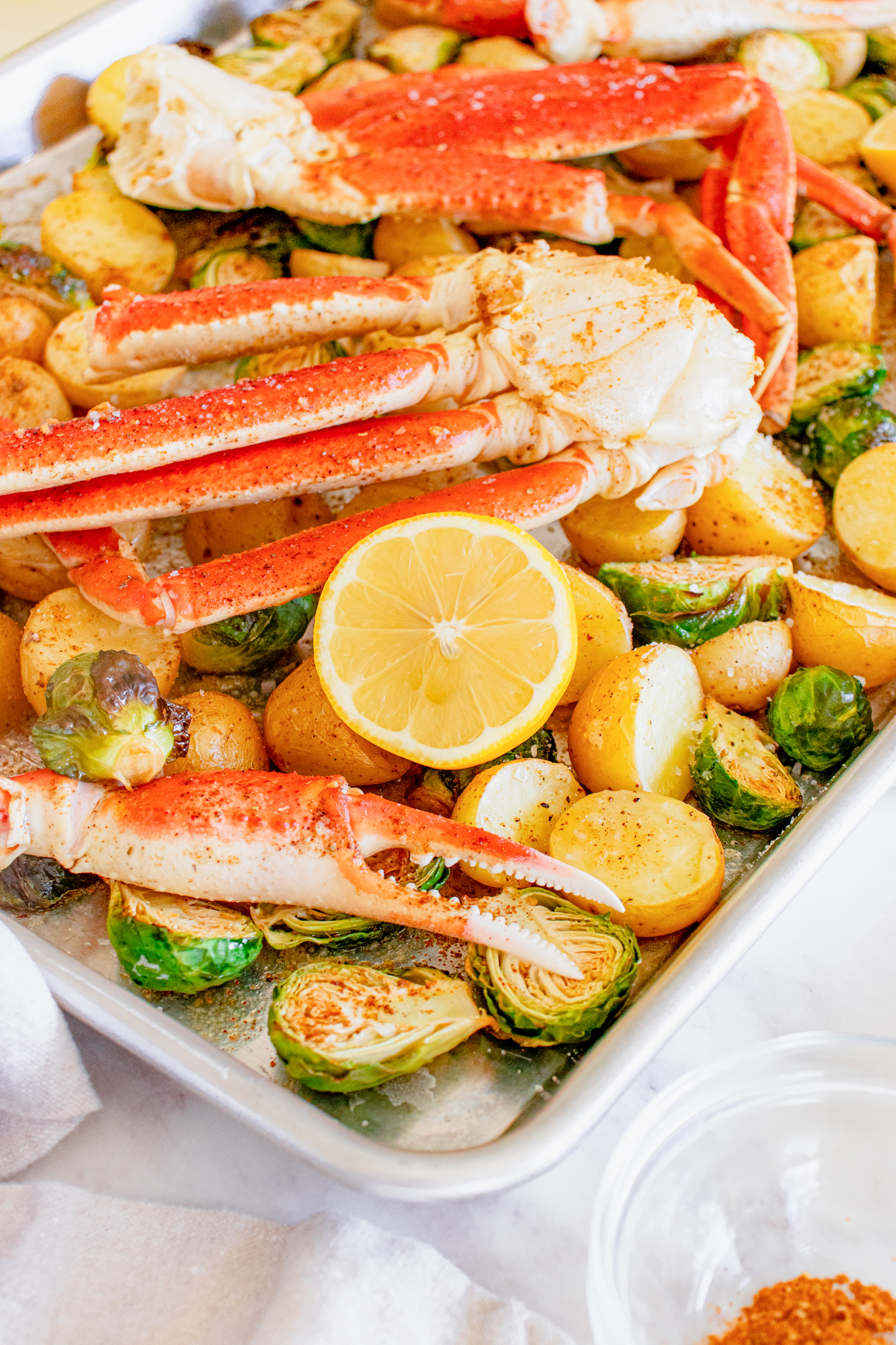 Garlic Butter Crab Legs with Roasted Brussels Sprouts + Potatoes